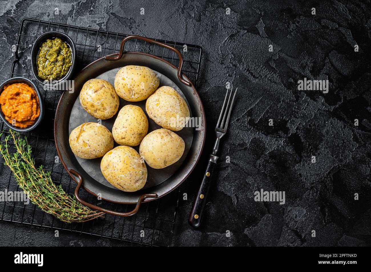 Canarian potatoes papas arrugadas with mojo, hot sauce. Black ...