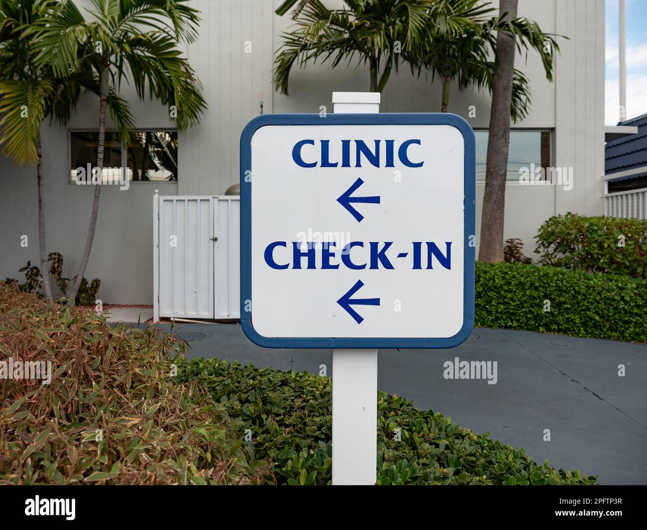 Clinic check-in inscription on sign post. Navigation sign. Wayfinding ...