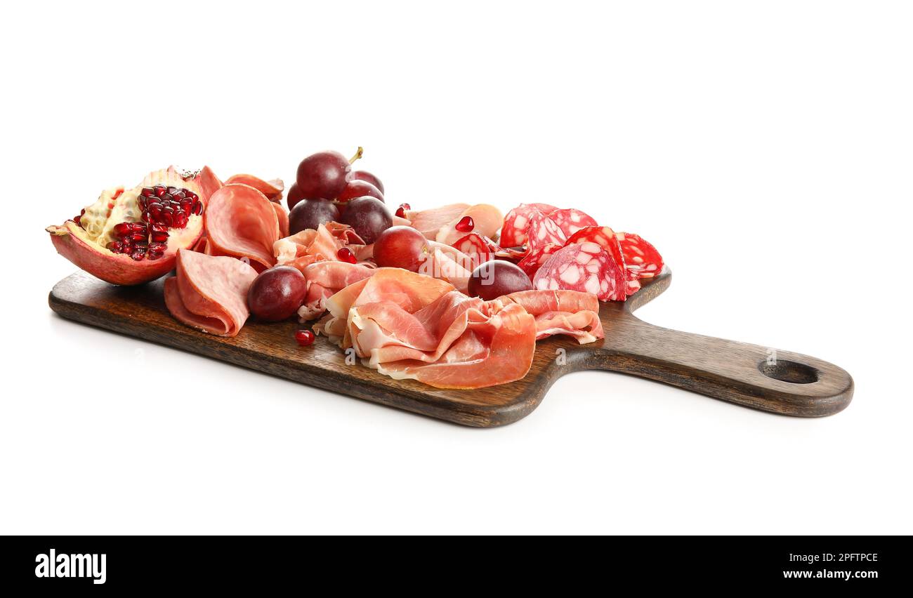 Wooden board with assortment of tasty deli meats isolated on white ...