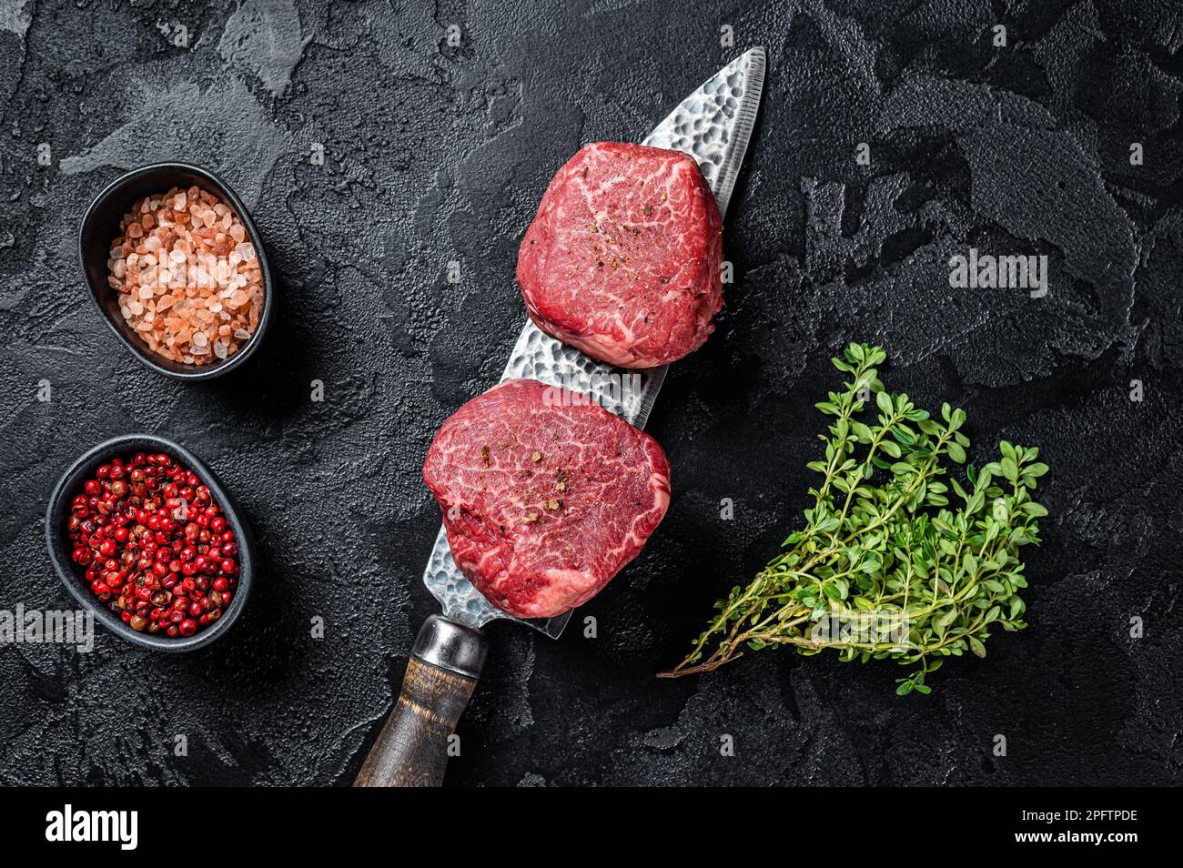 Fillet Mignon Beef steak, raw dry aged marble meat. Black background ...