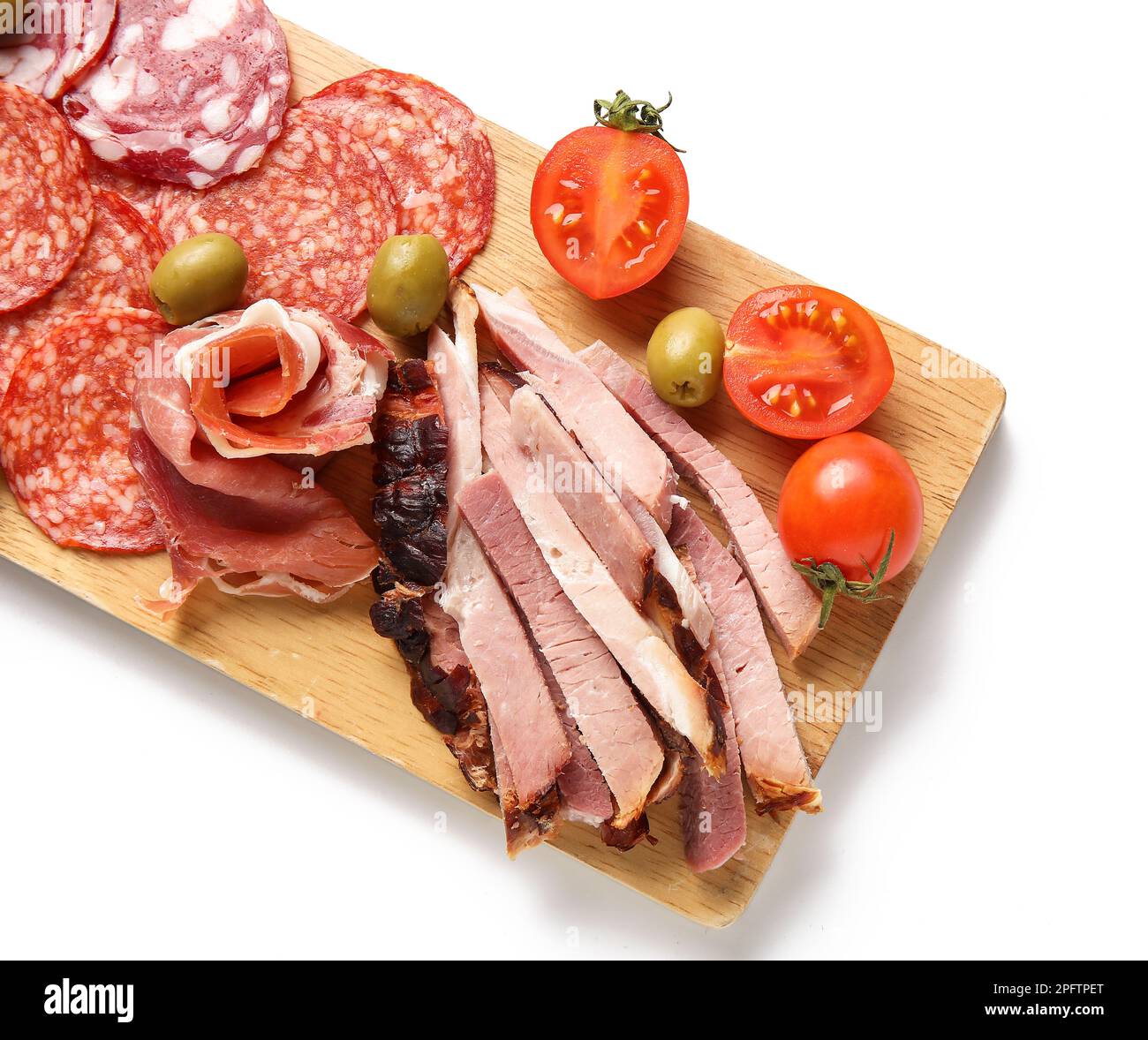 Wooden board with assortment of tasty deli meats isolated on white ...