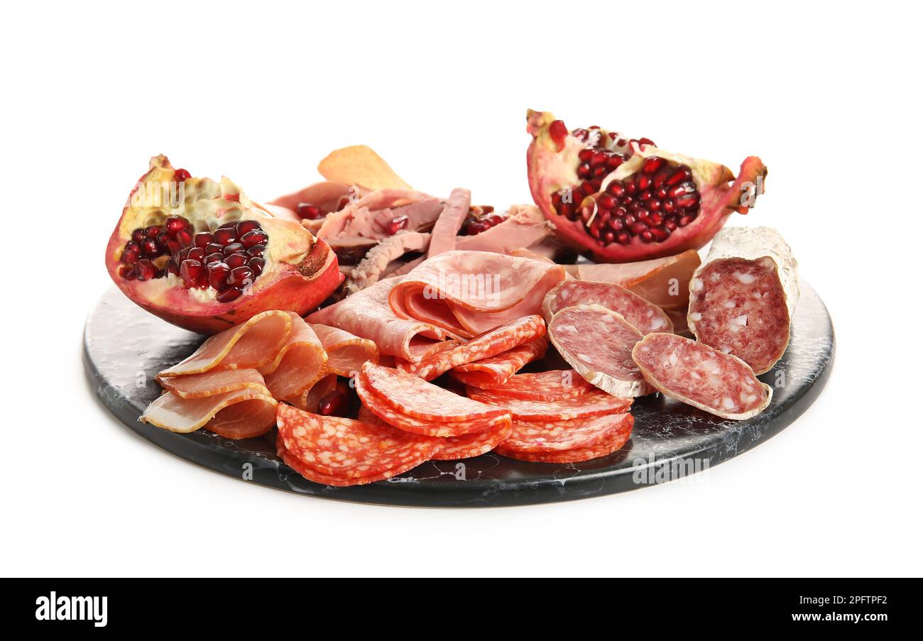 Slate plate with assortment of tasty deli meats isolated on white ...