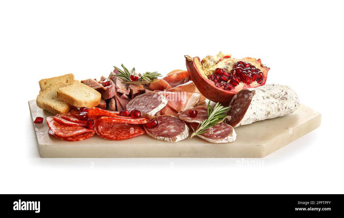 Board with assortment of tasty deli meats isolated on white background ...