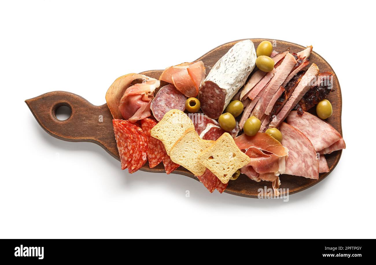 Wooden board with assortment of tasty deli meats isolated on white ...