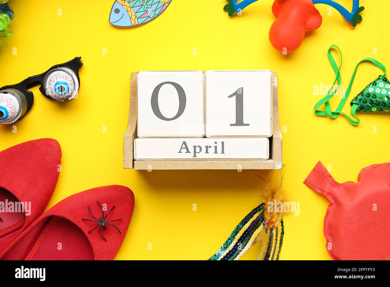 Calendar with date of April Fool's Day and funny decor on yellow ...