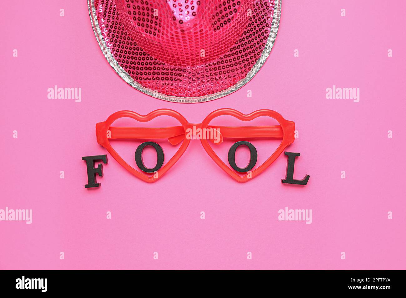 Word FOOL with eyeglasses and party hat on pink background Stock Photo ...