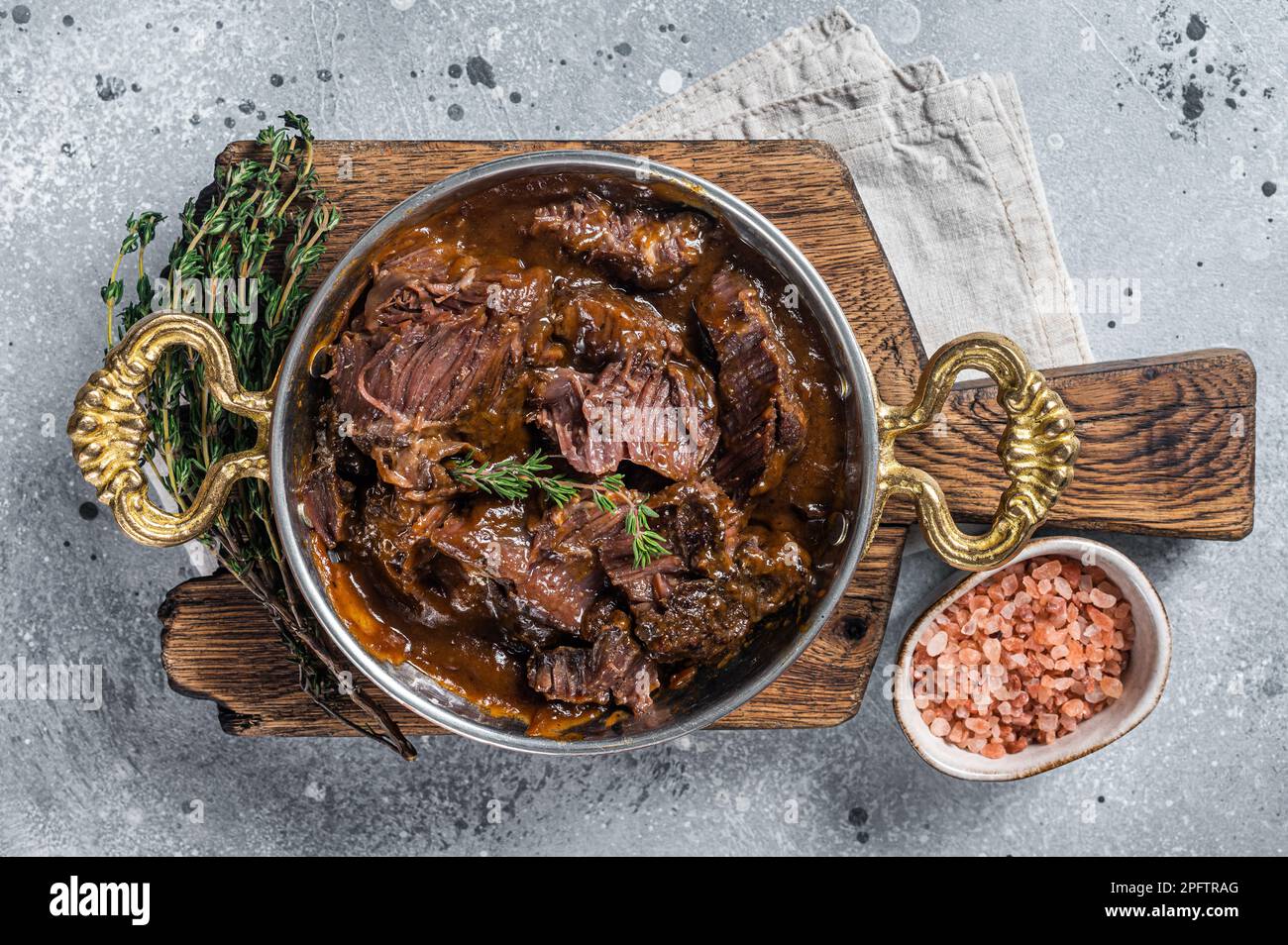 German braised beef cheeks in brown red wine sauce. Gray background ...