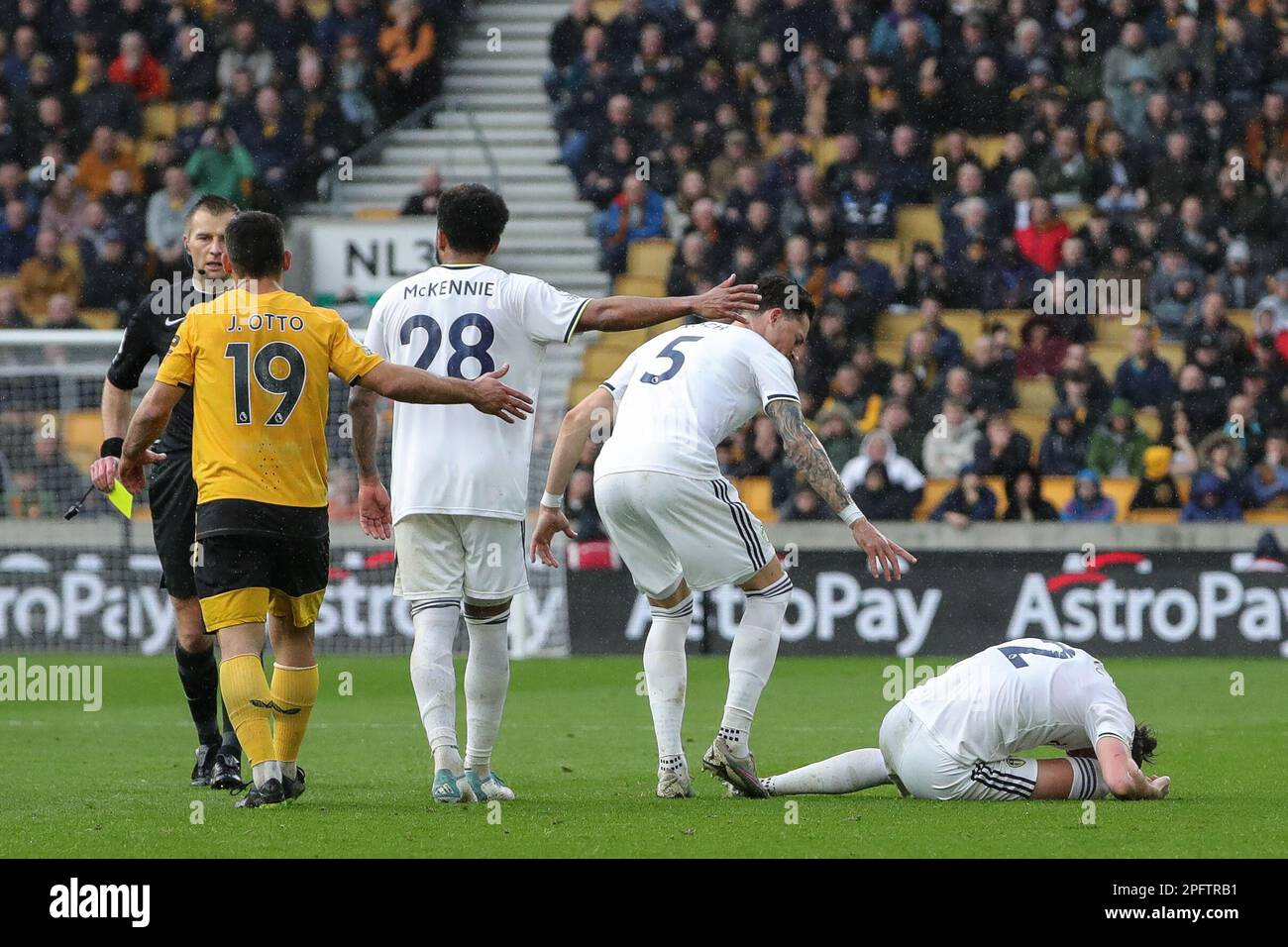 Referee Michael Salisbury awards a yellow card to Jonny #19 of ...