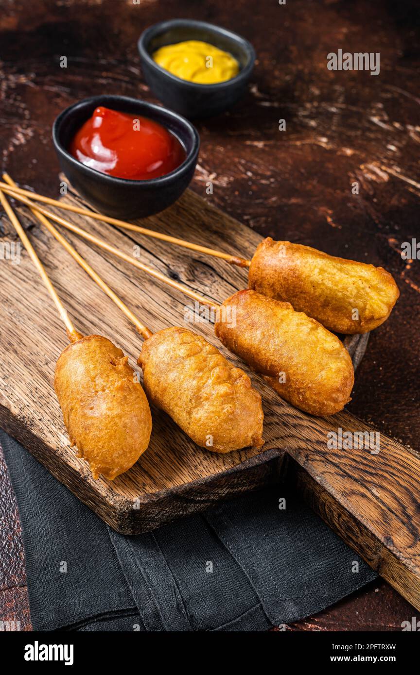Traditional American street junk food Deep fried corn dogs with mustard ...