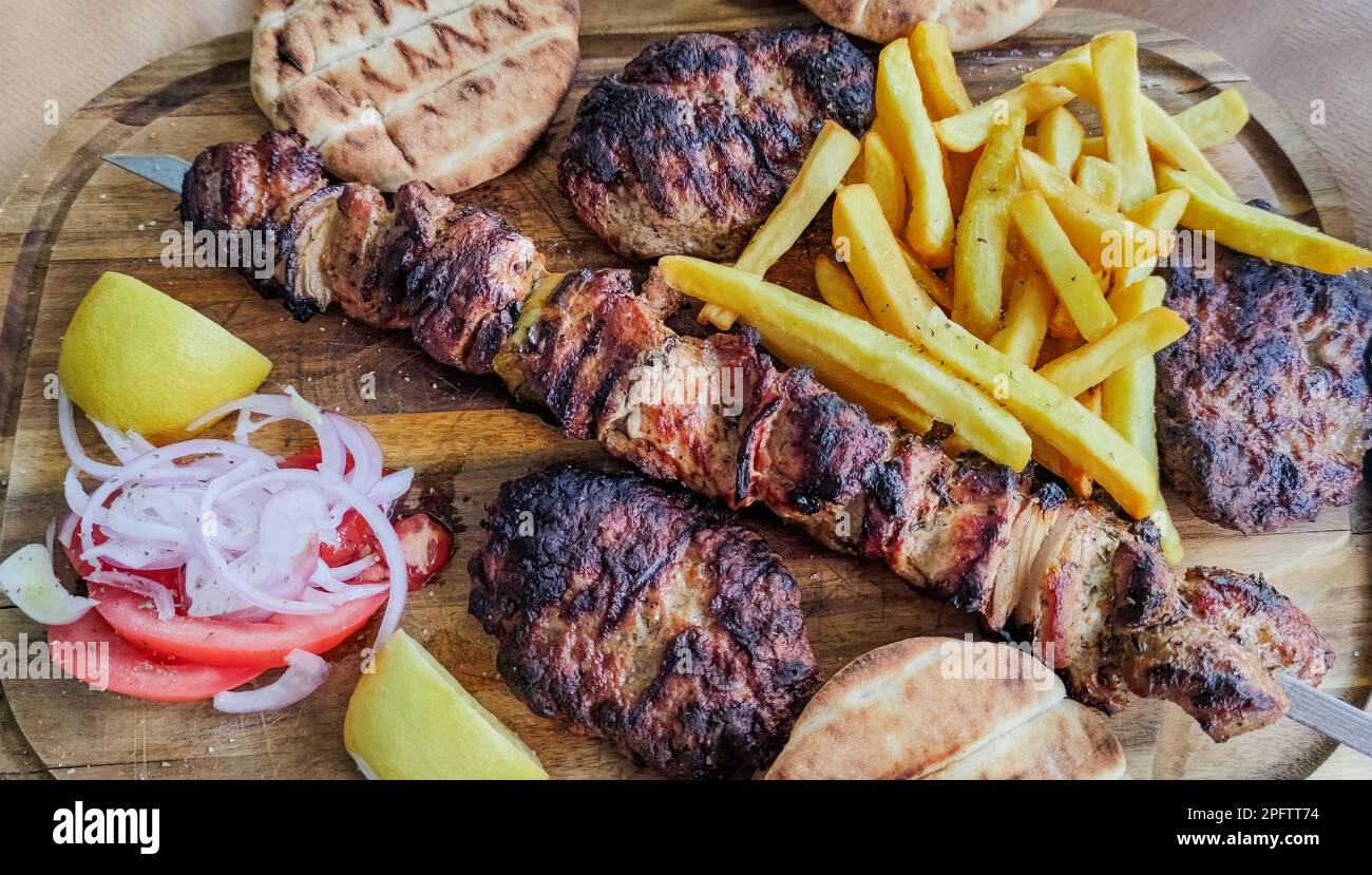 Greek kontosouvli large souvlaki made by fresh meat grilled on fire and ...