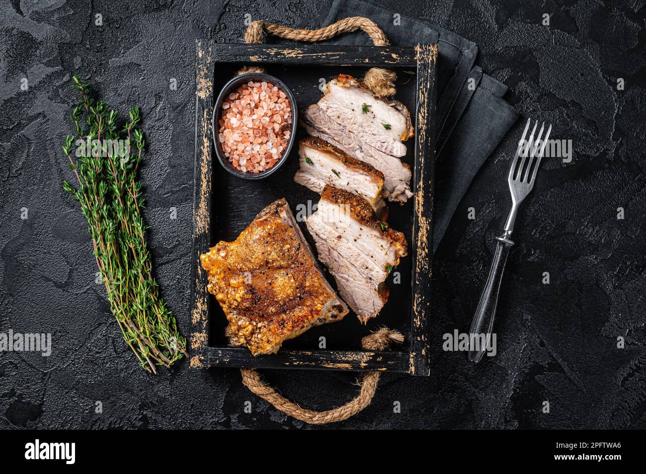Crispy Roast Pork Belly. Sliced roasted meat with crust in a tray with ...