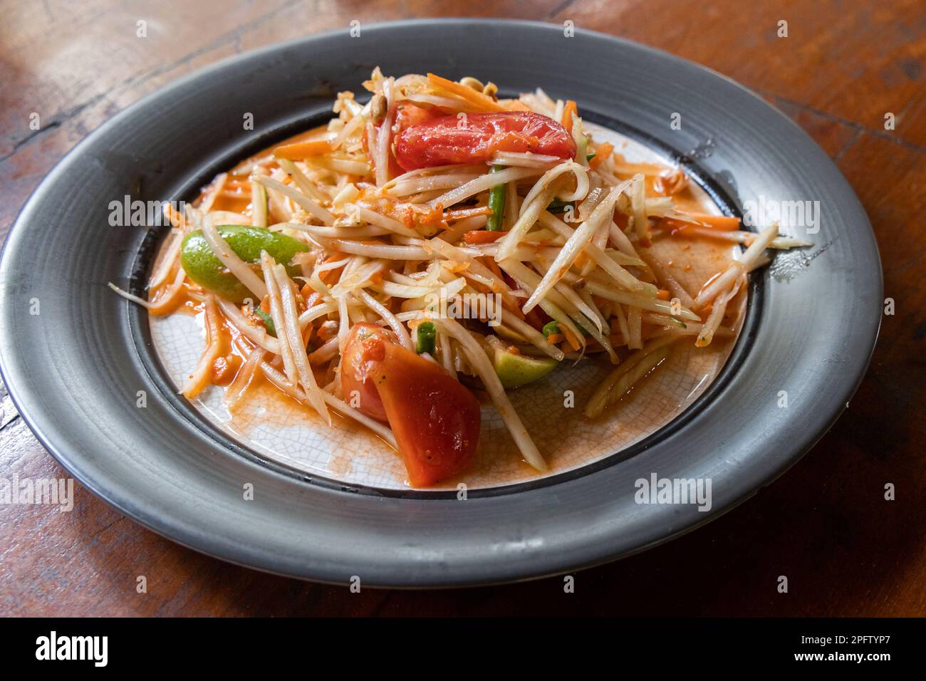 Serving of authentic Som Tam, or Thai salad made up of multiple fruits ...