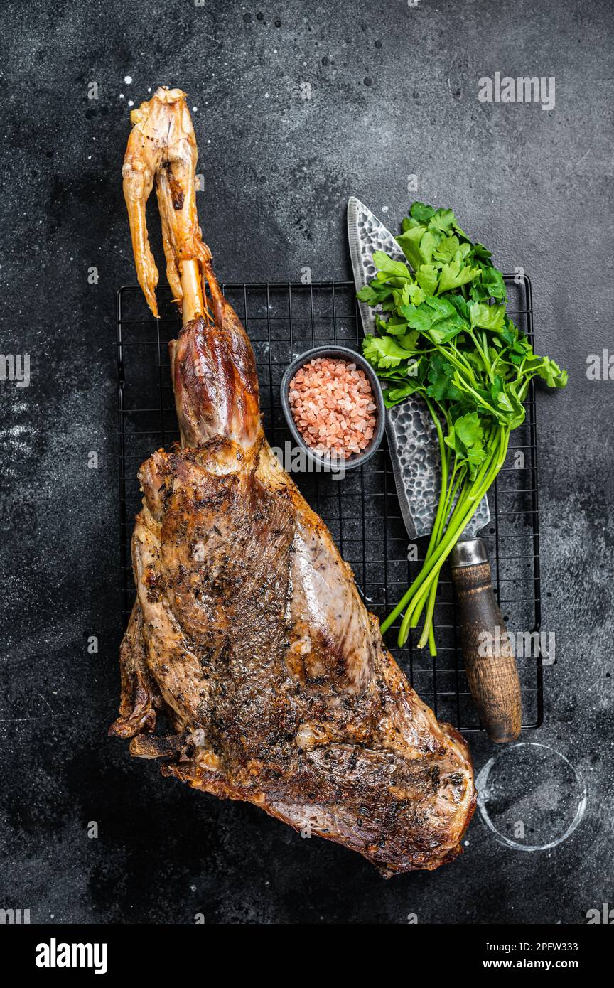 BBQ Roasted lamb mutton leg with herbs and spices on a grill. Black ...