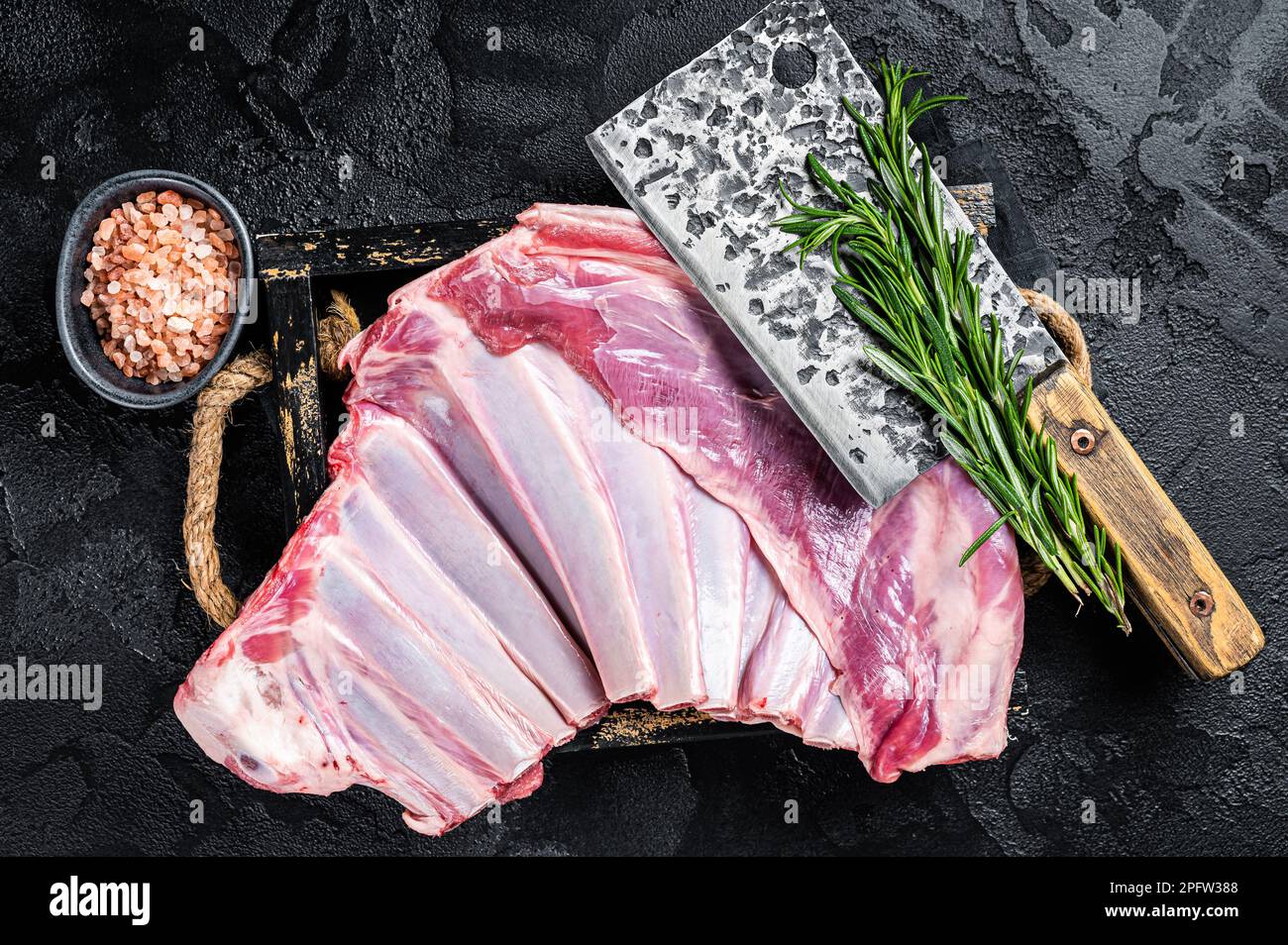 Butcher table with Rack of lamb, raw mutton ribs with meat cleaver ...