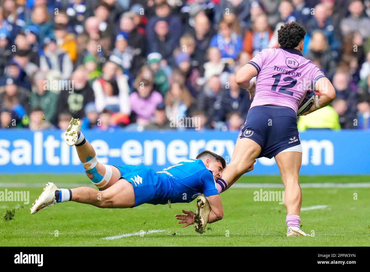 Alessandro Fusco #9 of Italy tackles Sione Tuipulotu #12 of Scotland ...