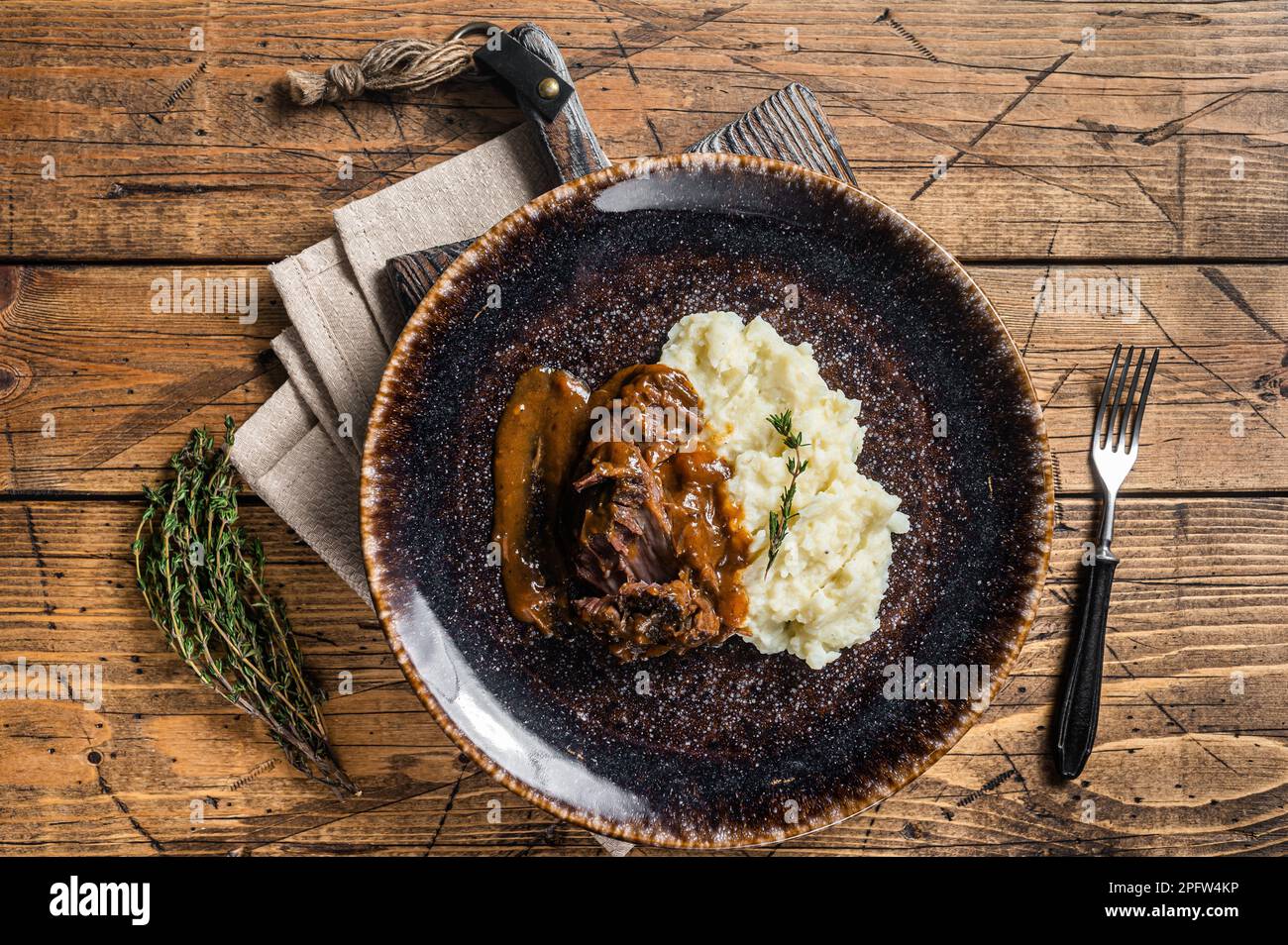 Beef cheeks stewed in red wine sauce with mashed potatoes. Wooden ...