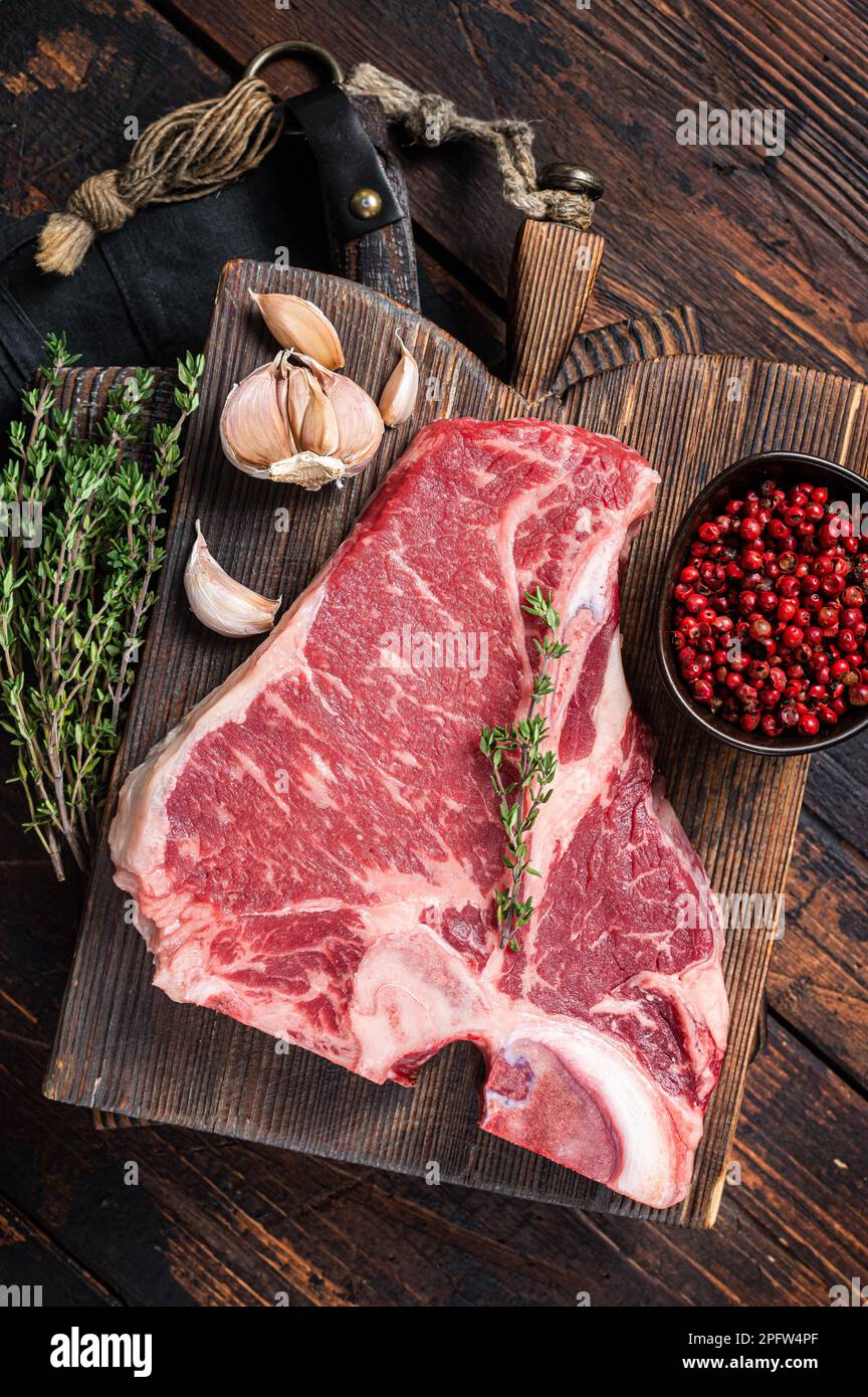 Prime T-bone beef meat steak, raw porterhouse steak on butcher board ...