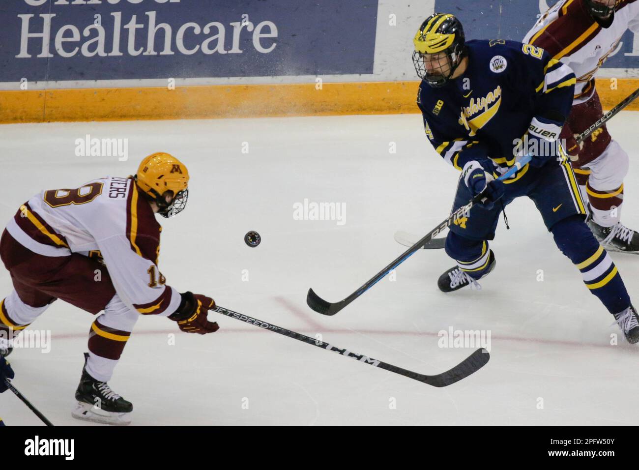 Michigan defenseman Steven Holtz (24) and Minnesota forward Mason ...