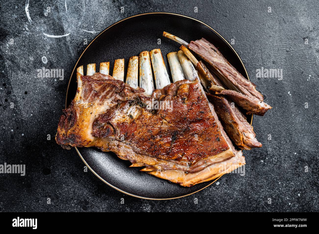 Roasted Rack of lamb ribs, mutton spareribs, sliced meat on plate ...