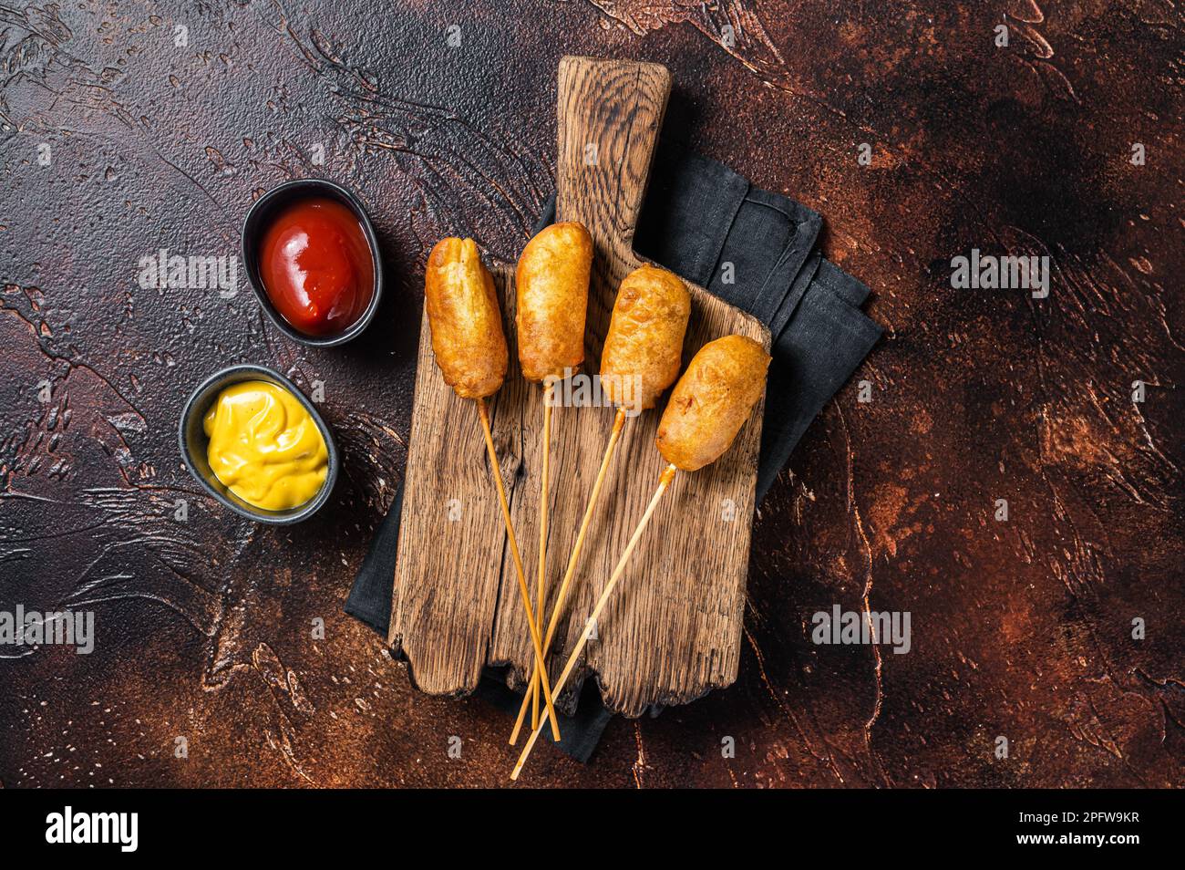 Traditional American street junk food Deep fried corn dogs with mustard ...