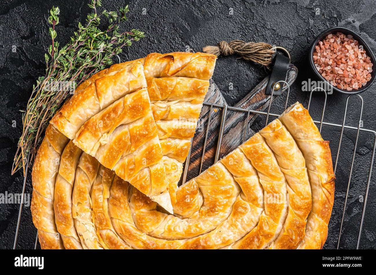 Turkish Tepsi Boregi, Round Borek cheese pie on kitchen board. Black ...