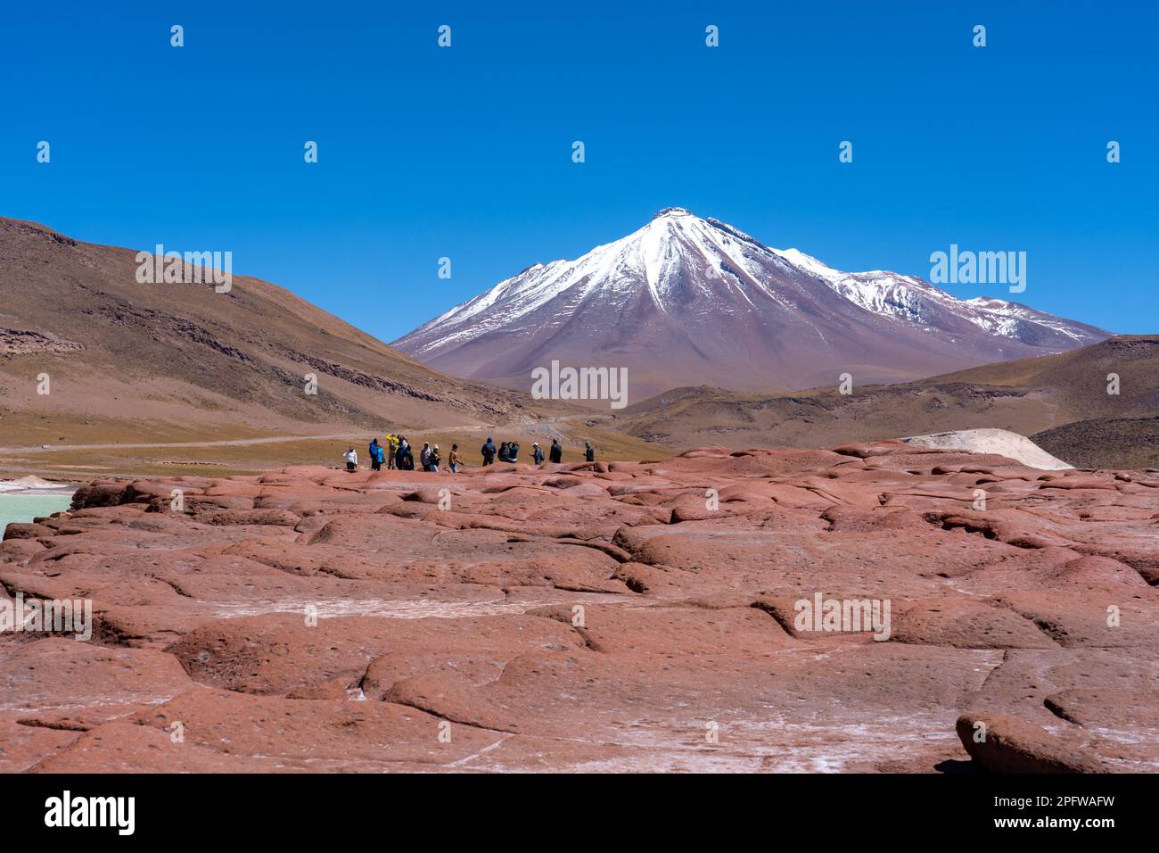 Red Rocks (Piedras Rojas), lagoon and salt flats with unrecognizable ...