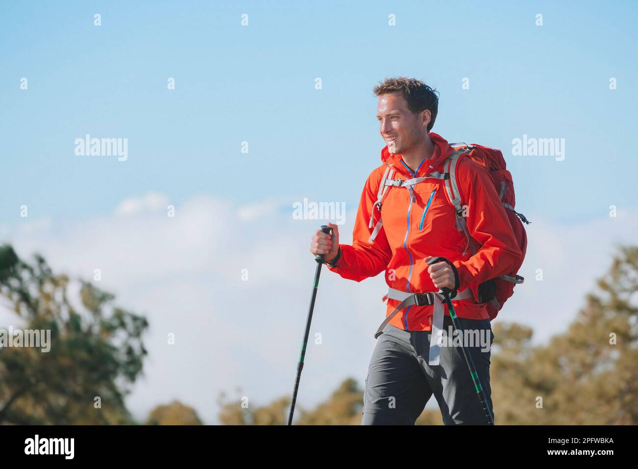 Man hiker hiking in mountain trail path on summer outdoor day wearing ...