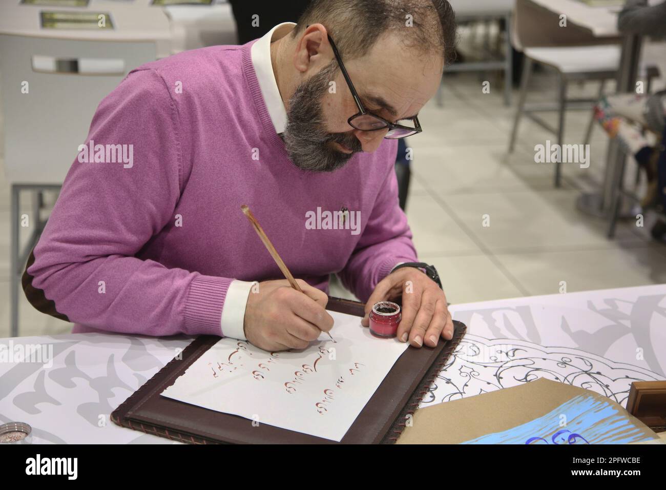 People take part in a traditional Farsi calligraphy workshop during ...