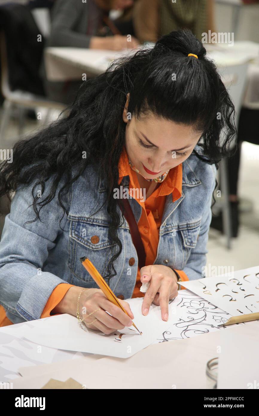 People take part in a traditional Farsi calligraphy workshop during ...