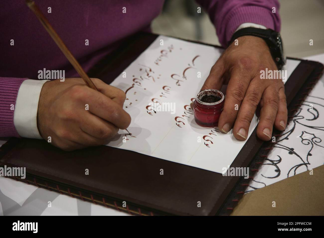 People take part in a traditional Farsi calligraphy workshop during ...