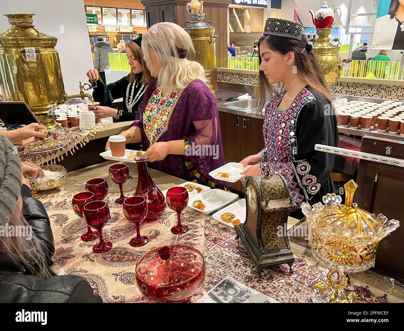 Iranian women serve tea from a traditional samovar during Nevruz ...