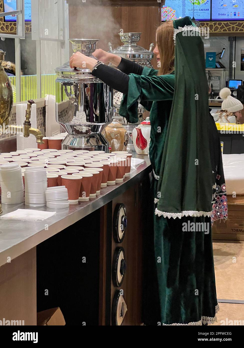 Iranian women serve tea from a traditional samovar during Nevruz ...