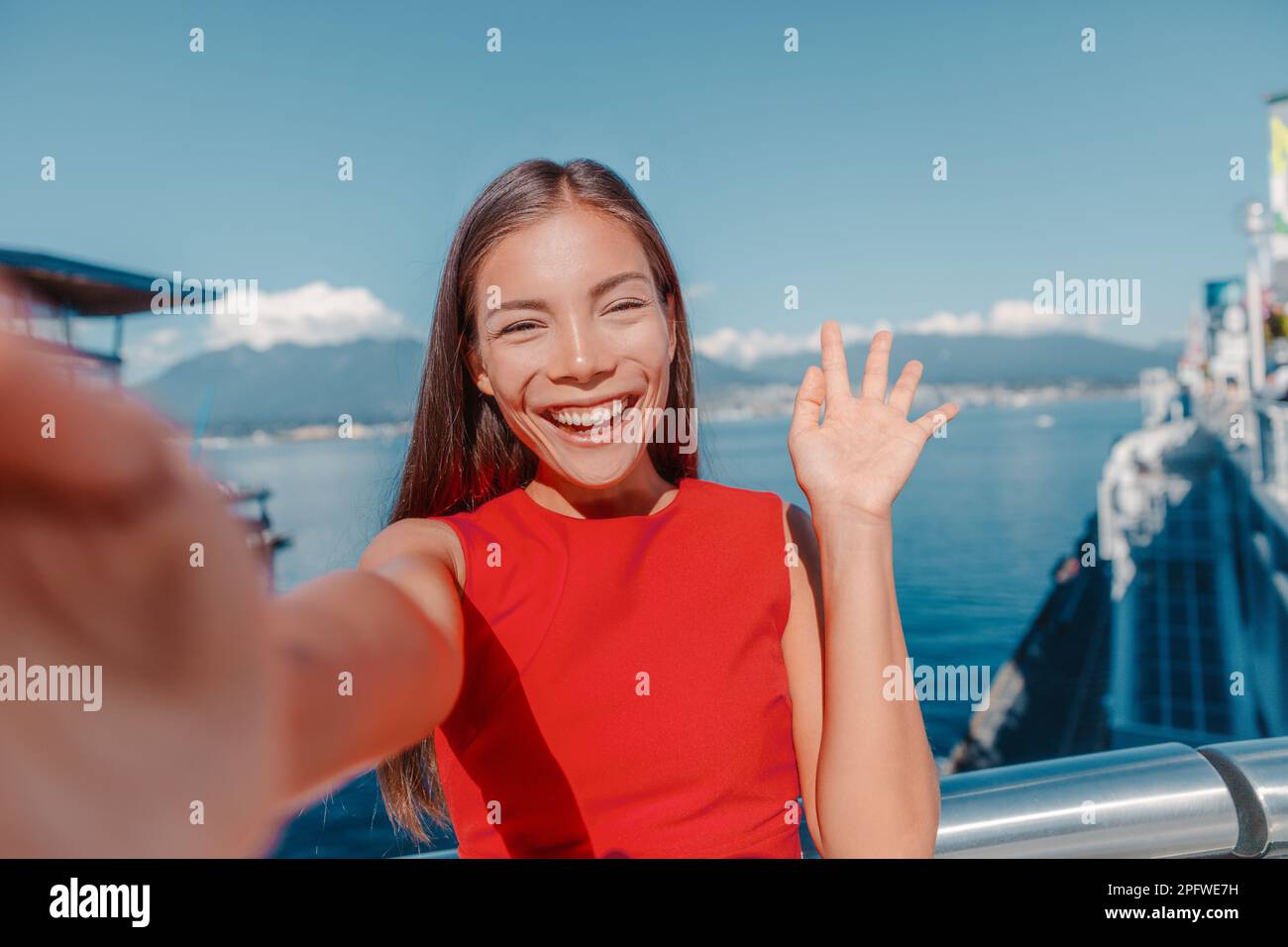 Asian business woman selfie waving hello looking at camera on video ...