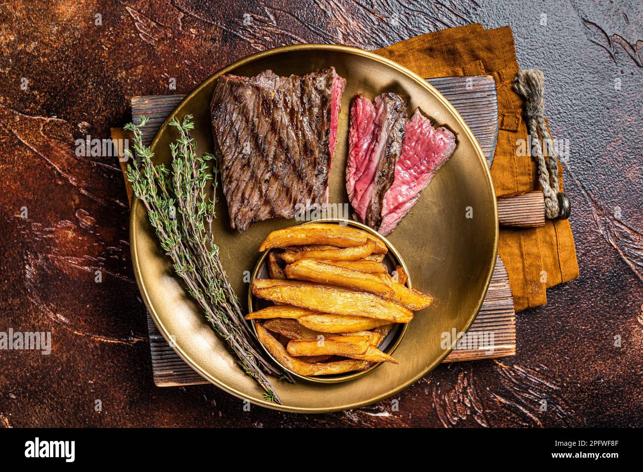 Elk steak with herbs and french fry, game meat. Dark background. Top ...