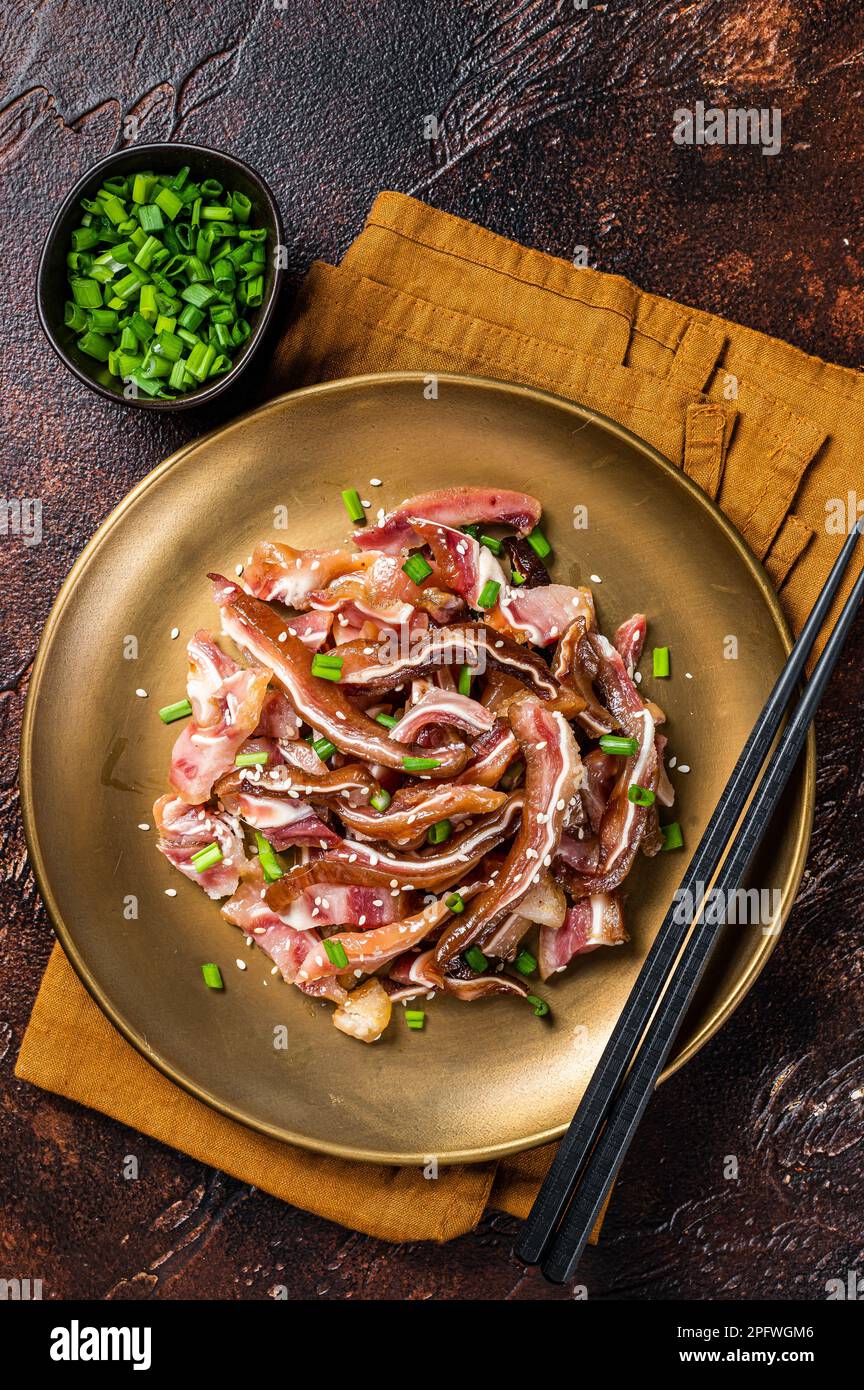 Asian appetizer pig pork ears with sesame seeds, green onion and spicy ...