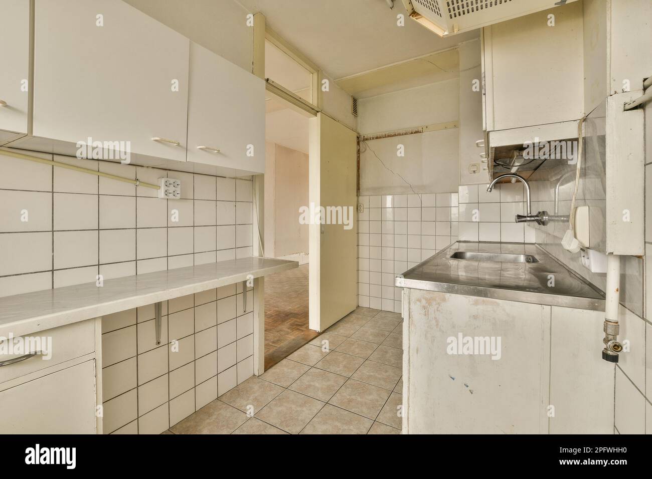 an empty kitchen with white cabinets and counter space in the middle of ...