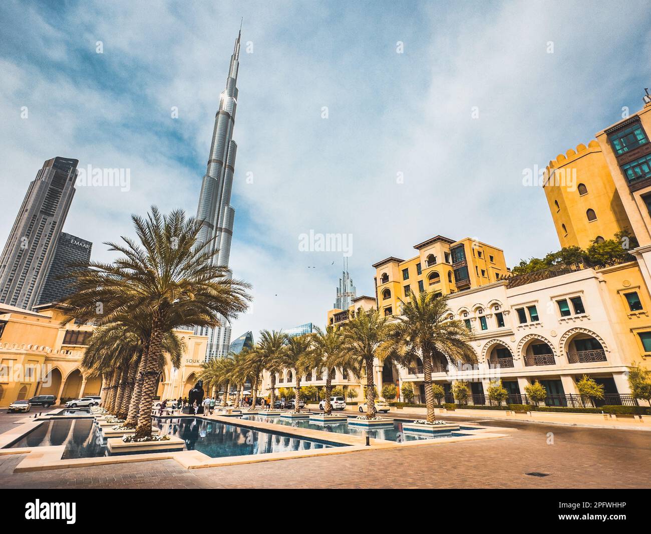 Dubai Downtown. square place with palm trees and pond with burj khalifa ...
