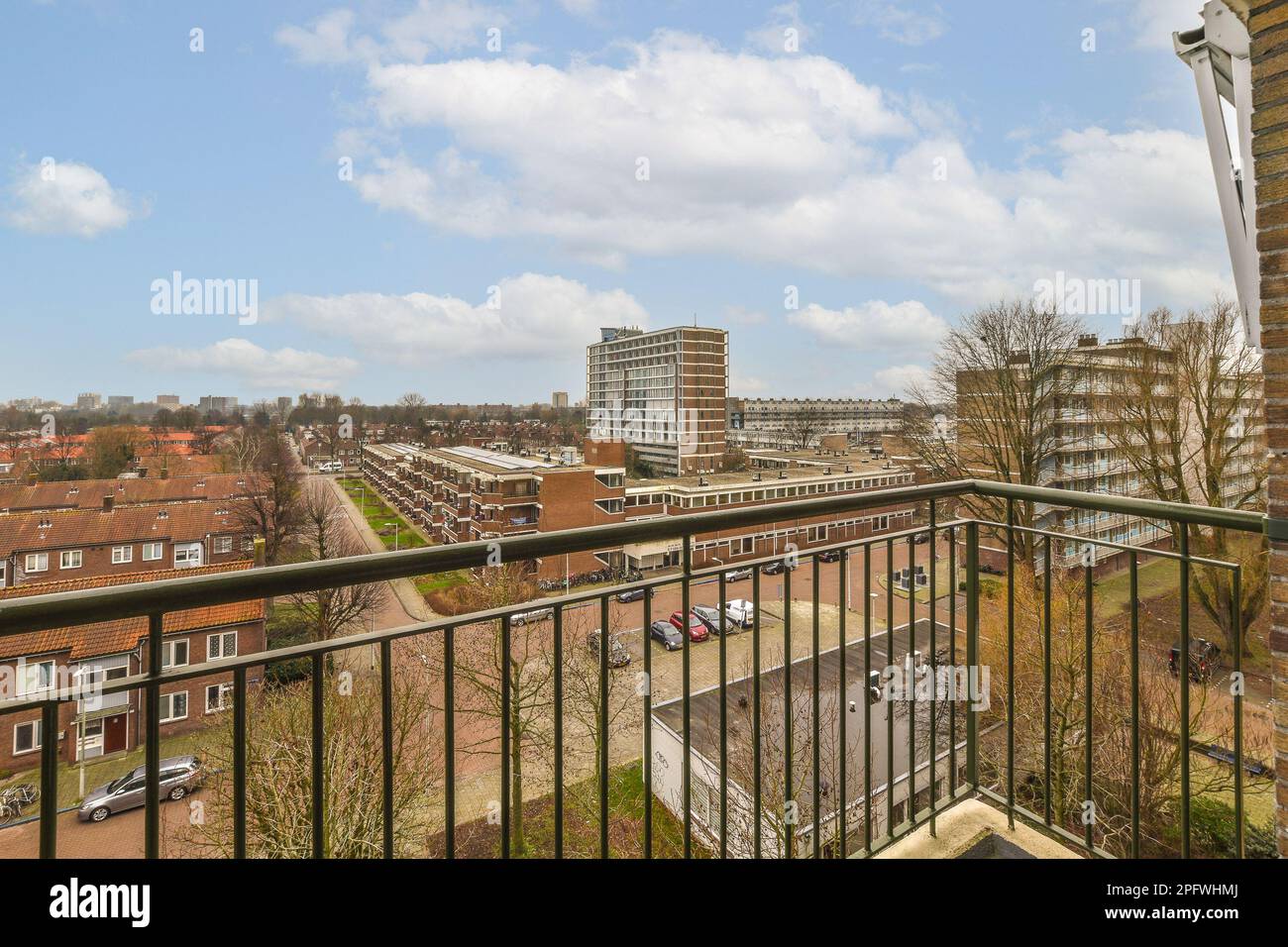 a balcony with some buildings in the background and blue sky above it ...