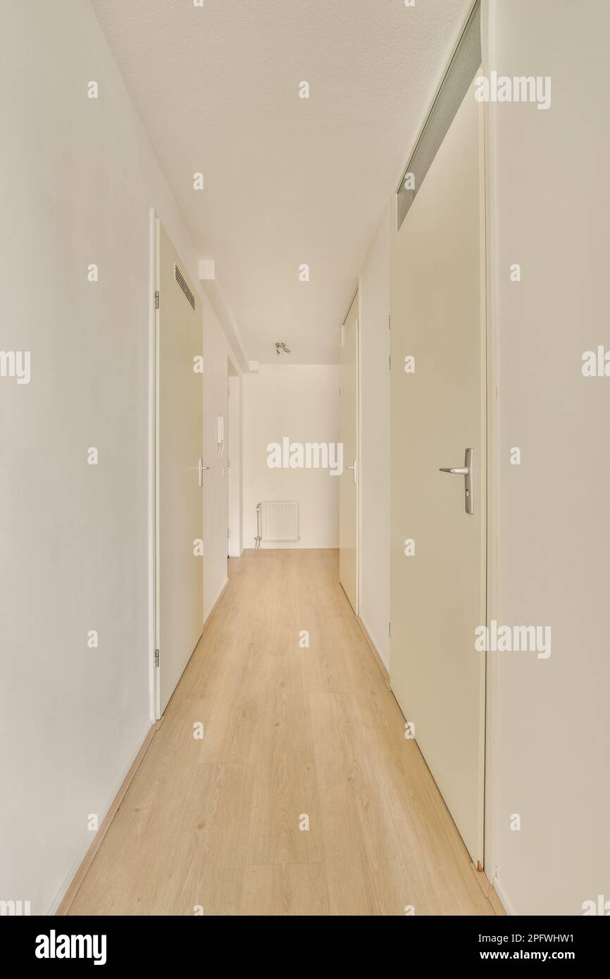 an empty room with white walls and wood flooring on the right side of ...