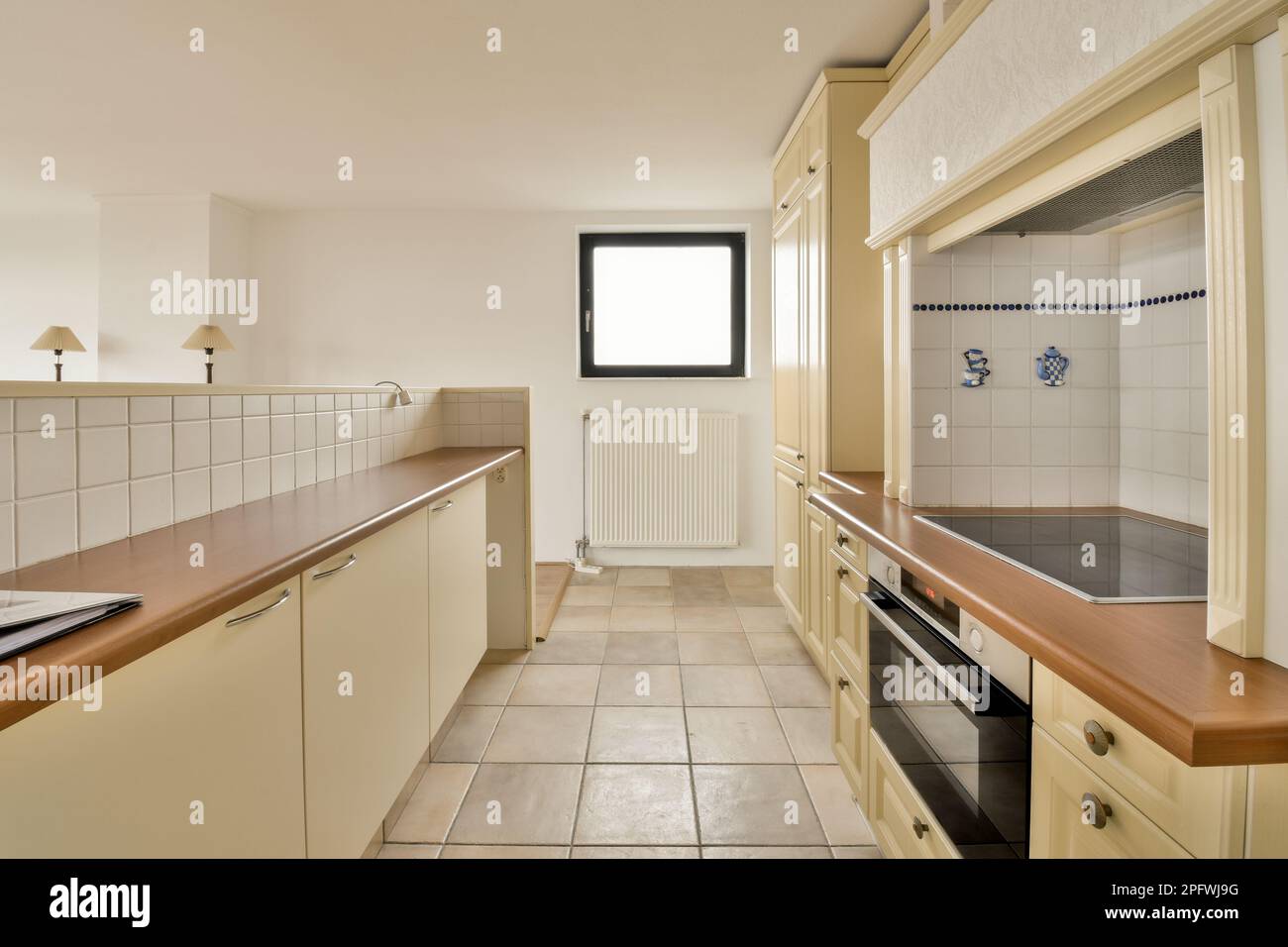 a kitchen with white tiles and light wood counter tops on the counters ...