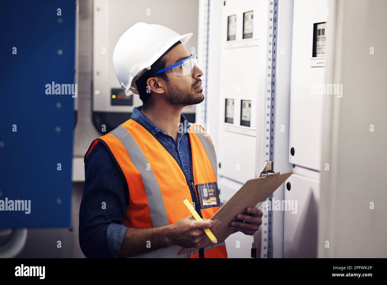 Man, engineering and clipboard in control room, box inspection and ...