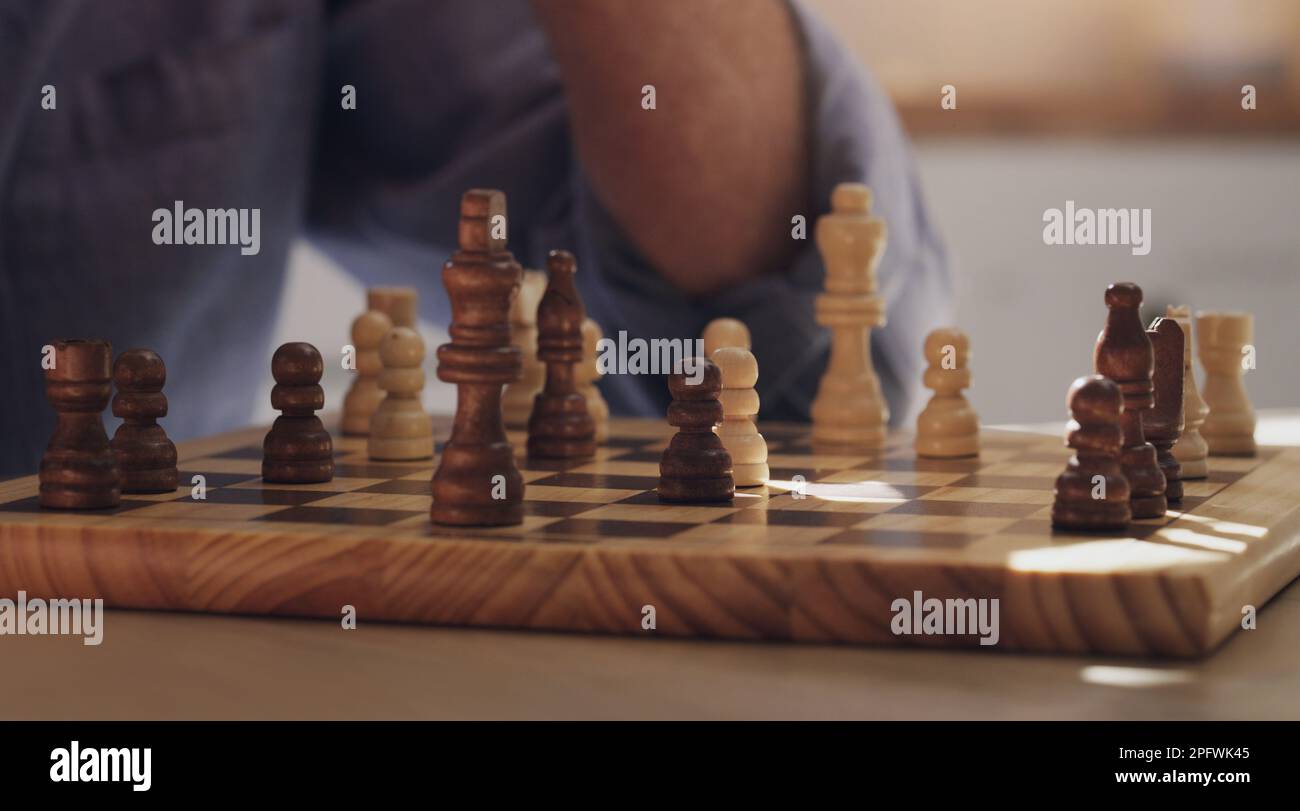 Keeping our brains active with a game of chess. an unrecognizable man ...