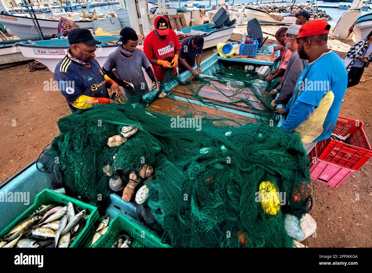Cleaning fishing nets at the Fish Market, Mutrah Souq, Muscat, Oman ...