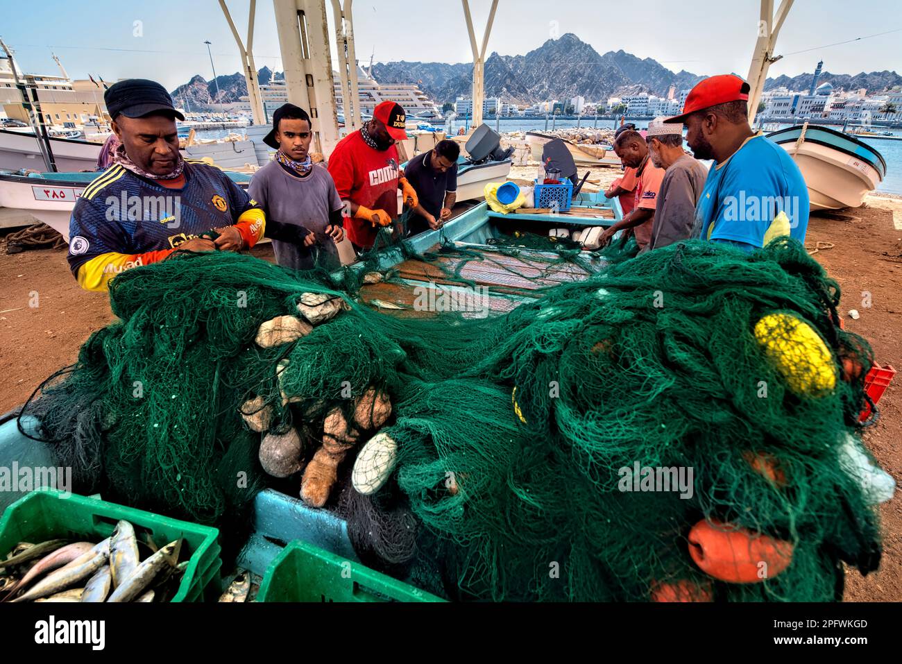 Cleaning fishing nets at the Fish Market, Mutrah Souq, Muscat, Oman ...