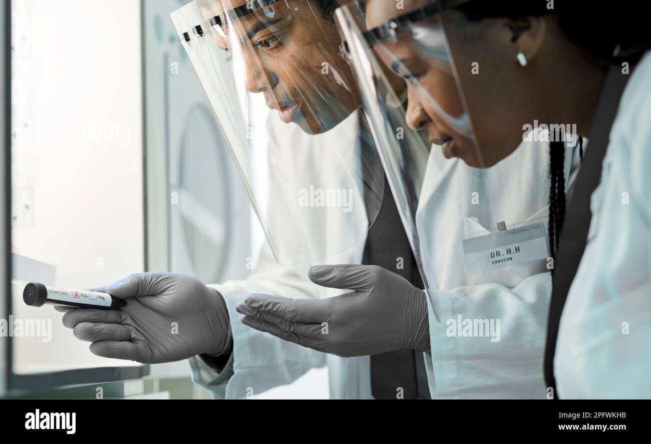 Changing the future for the better. two scientists wearing face shields ...