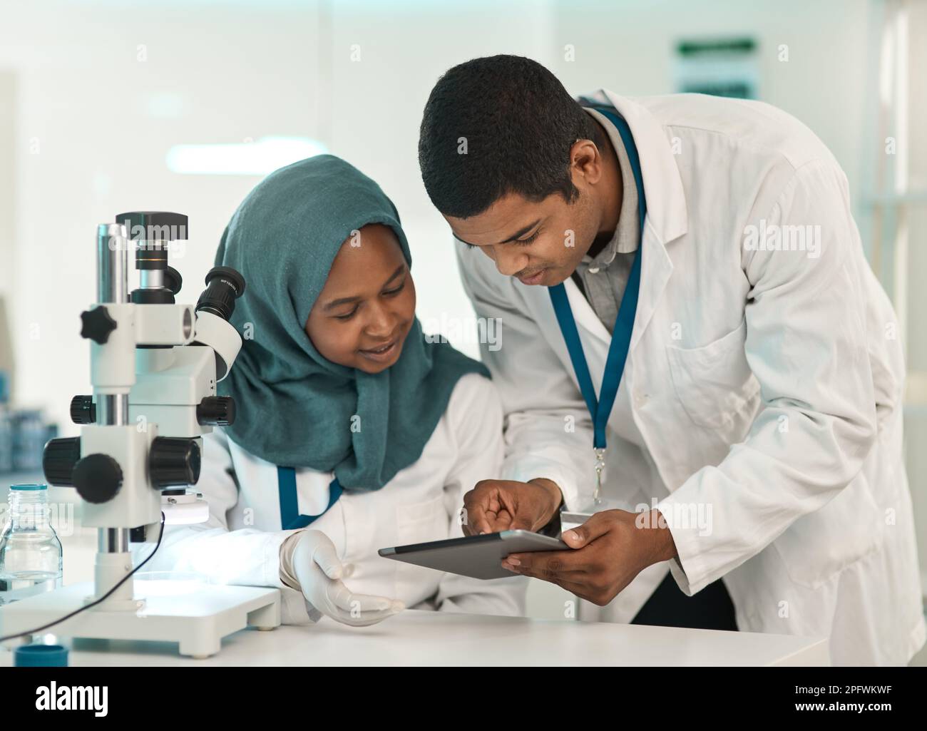 Conducting cutting edge research thatll transform the world. two scientists using a digital ...