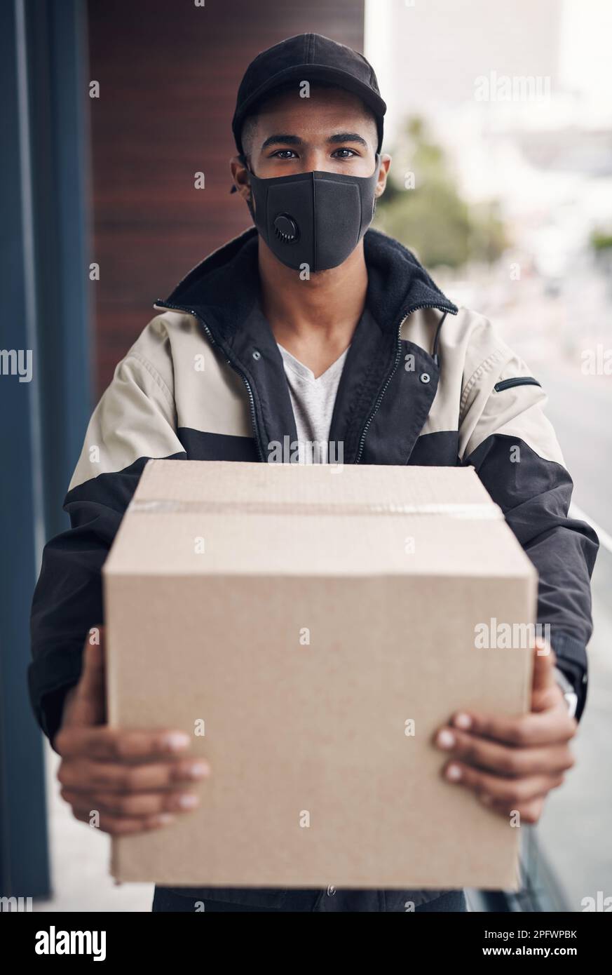 Delivering your goods safe and without delay. a masked young man ...