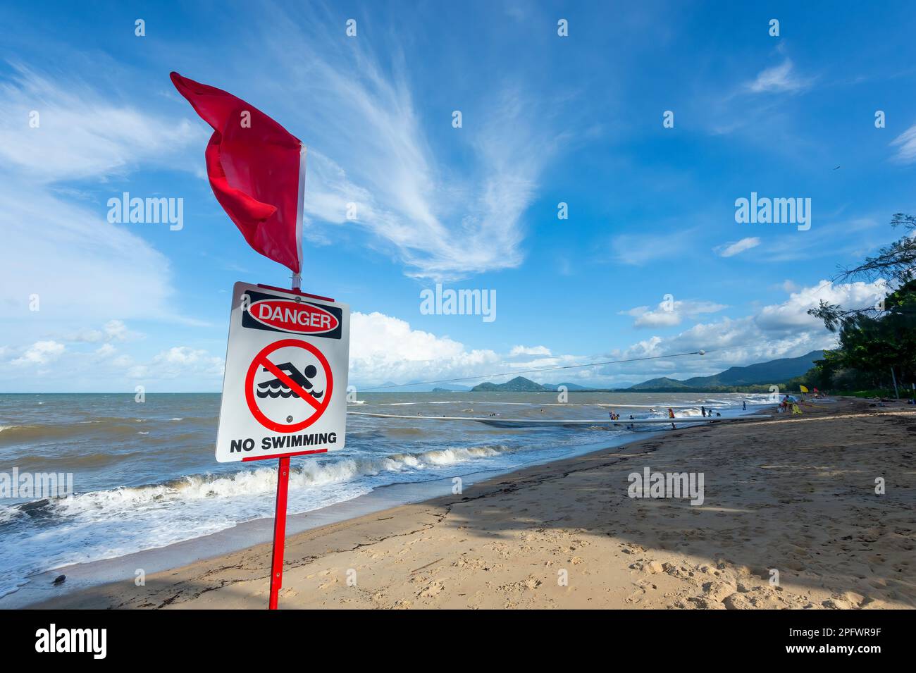 Red flag with sign Danger No Swimming at Palm Cove, Cairns Northern ...