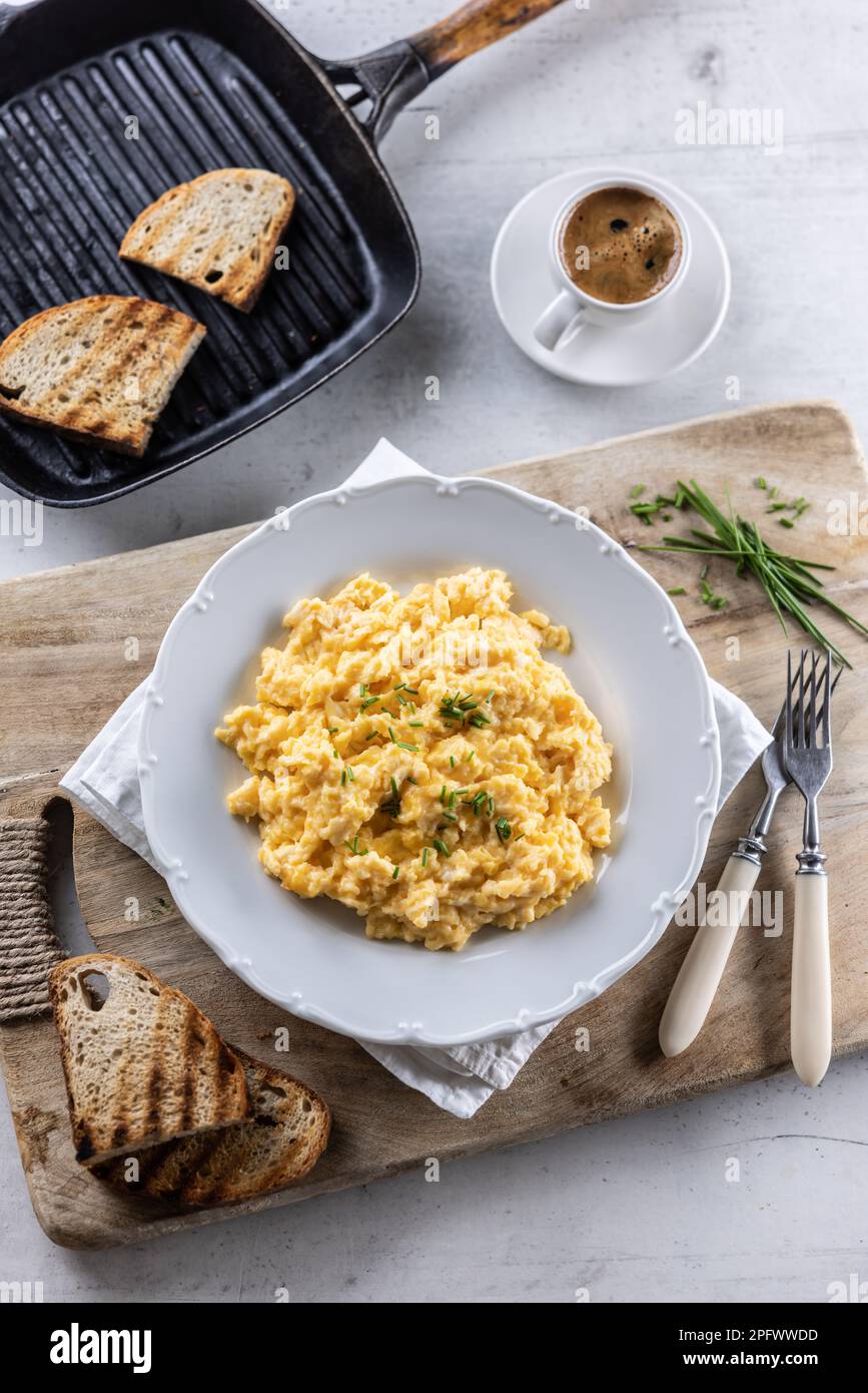 Top view of traditional breakfast with scrambled eggs, bread toasts and ...