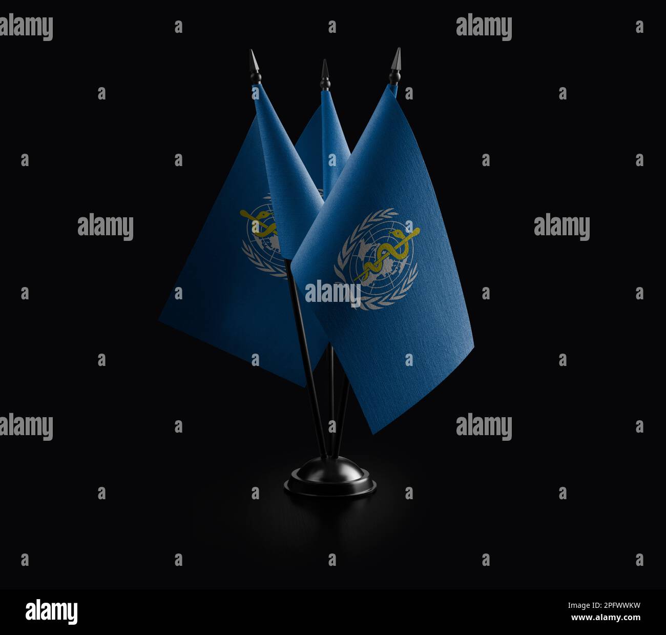 Small national flags of the World Health Organization WHO on a black ...